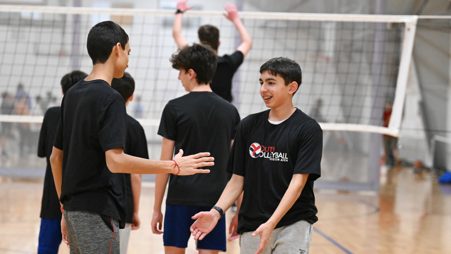 Youth volleyball boys players high five low five